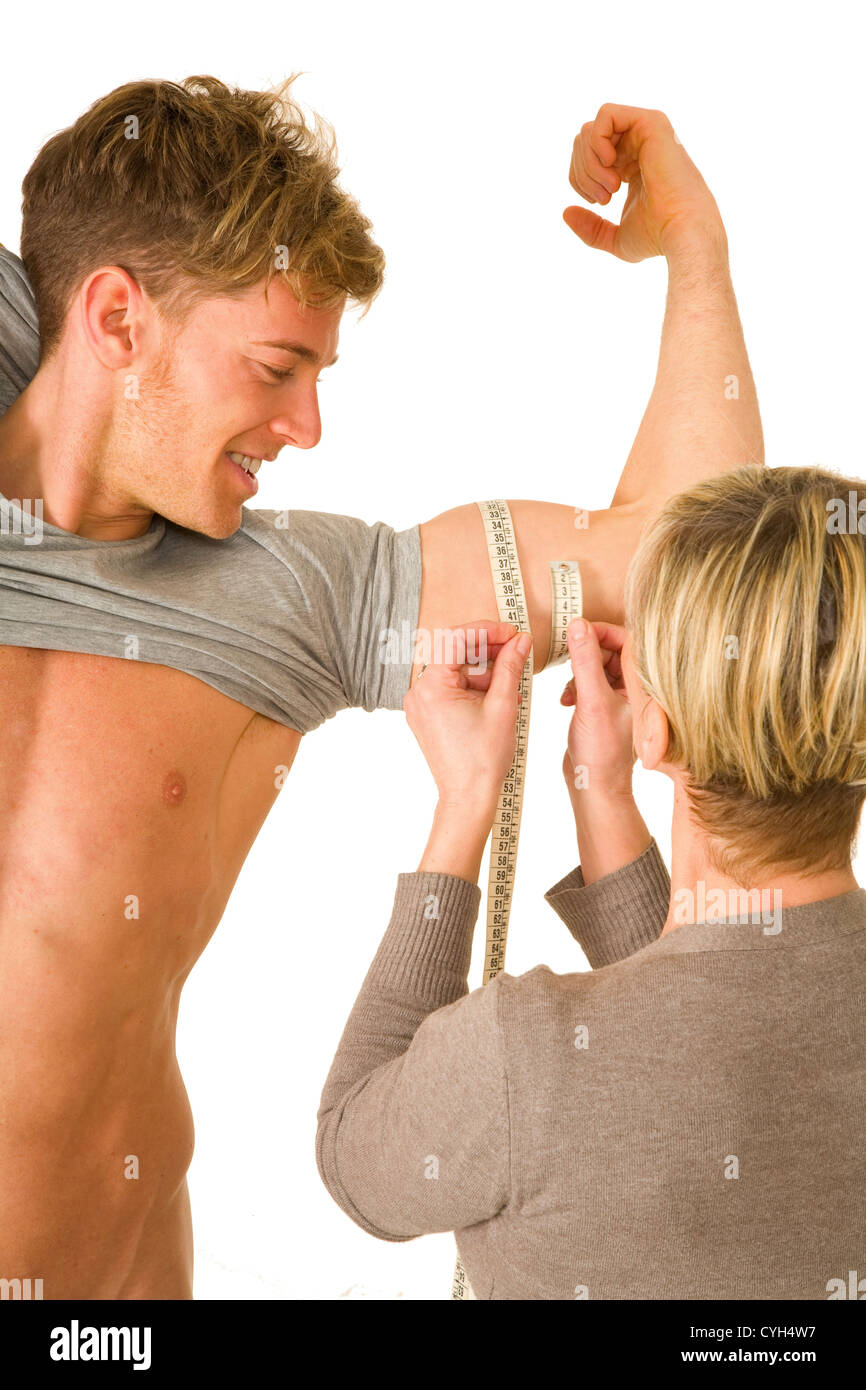 woman measuring biceps of a young man Stock Photo - Alamy