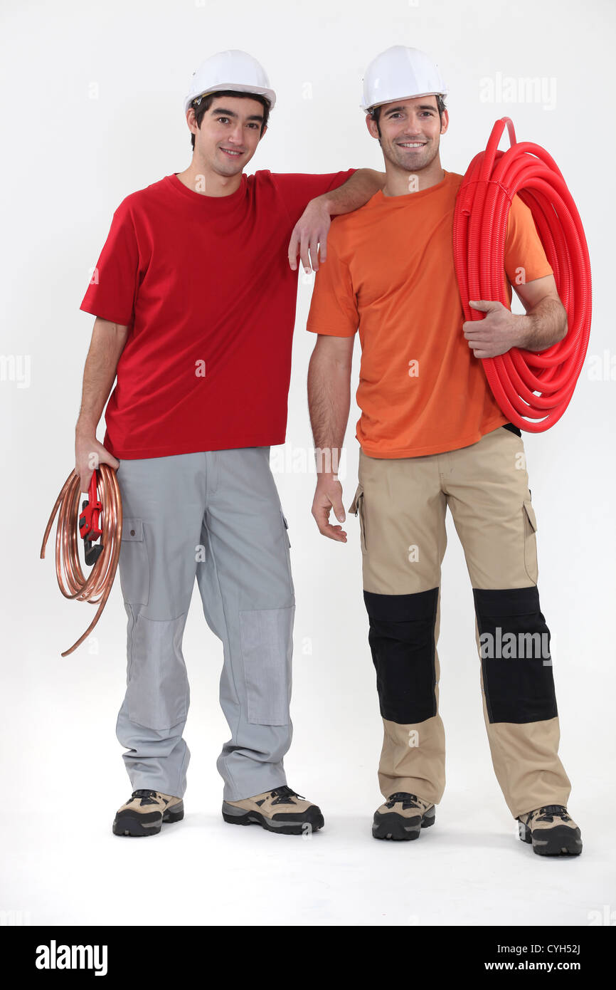 Two plumbers on white background Stock Photo - Alamy