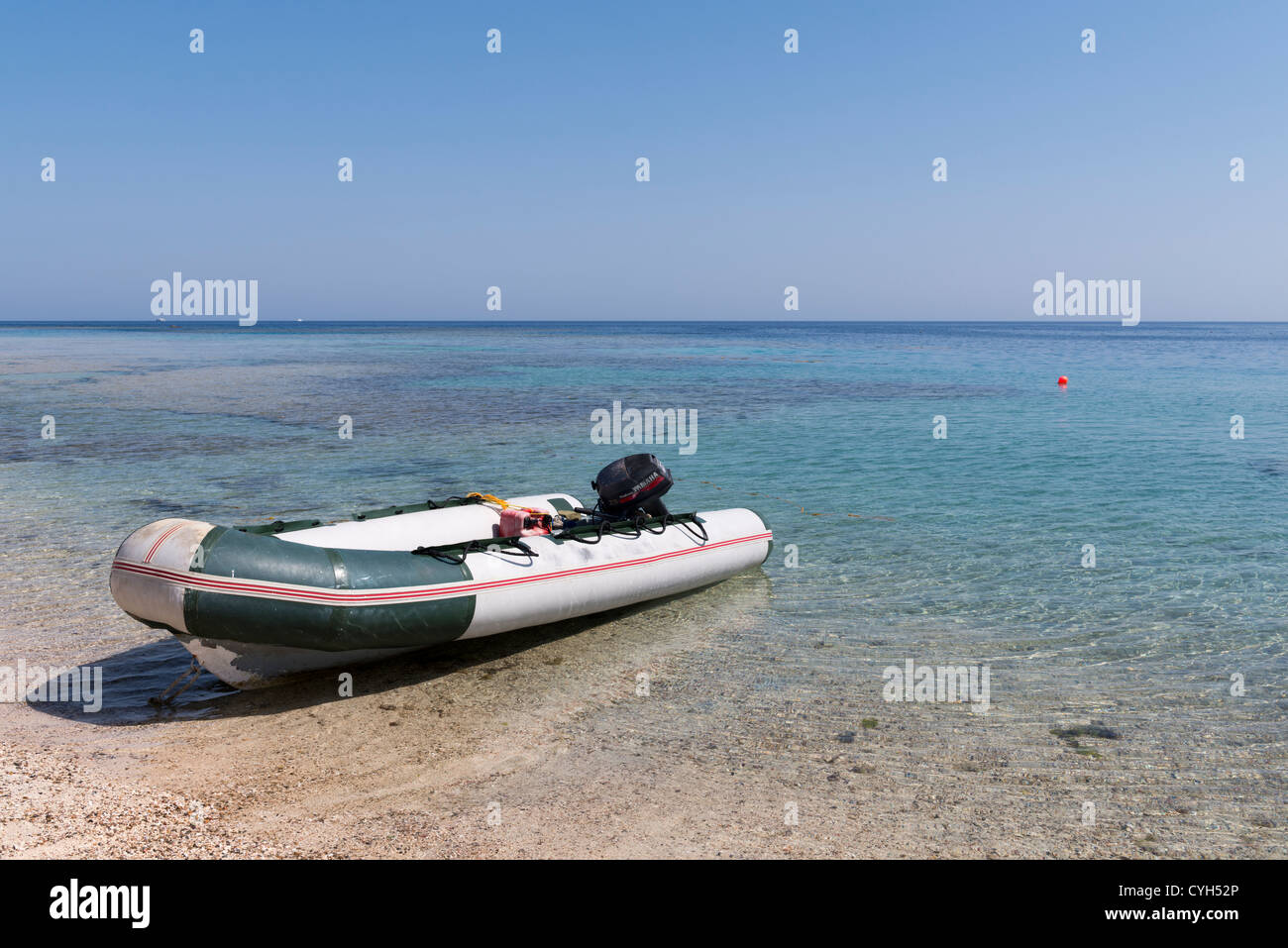 Inflatable sea boat with motor on the beach Stock Photo - Alamy