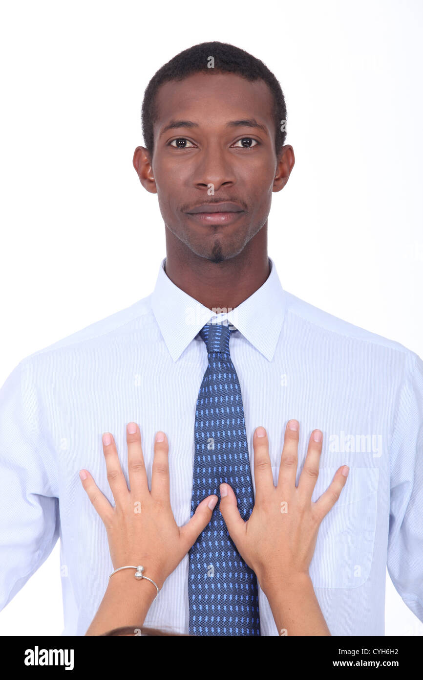 Woman putting hands on businessman's chest Stock Photo - Alamy