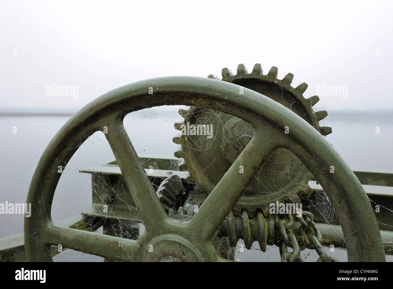 wheel of an old mechanical sluice with spiderwebs at misty lake Stock ...