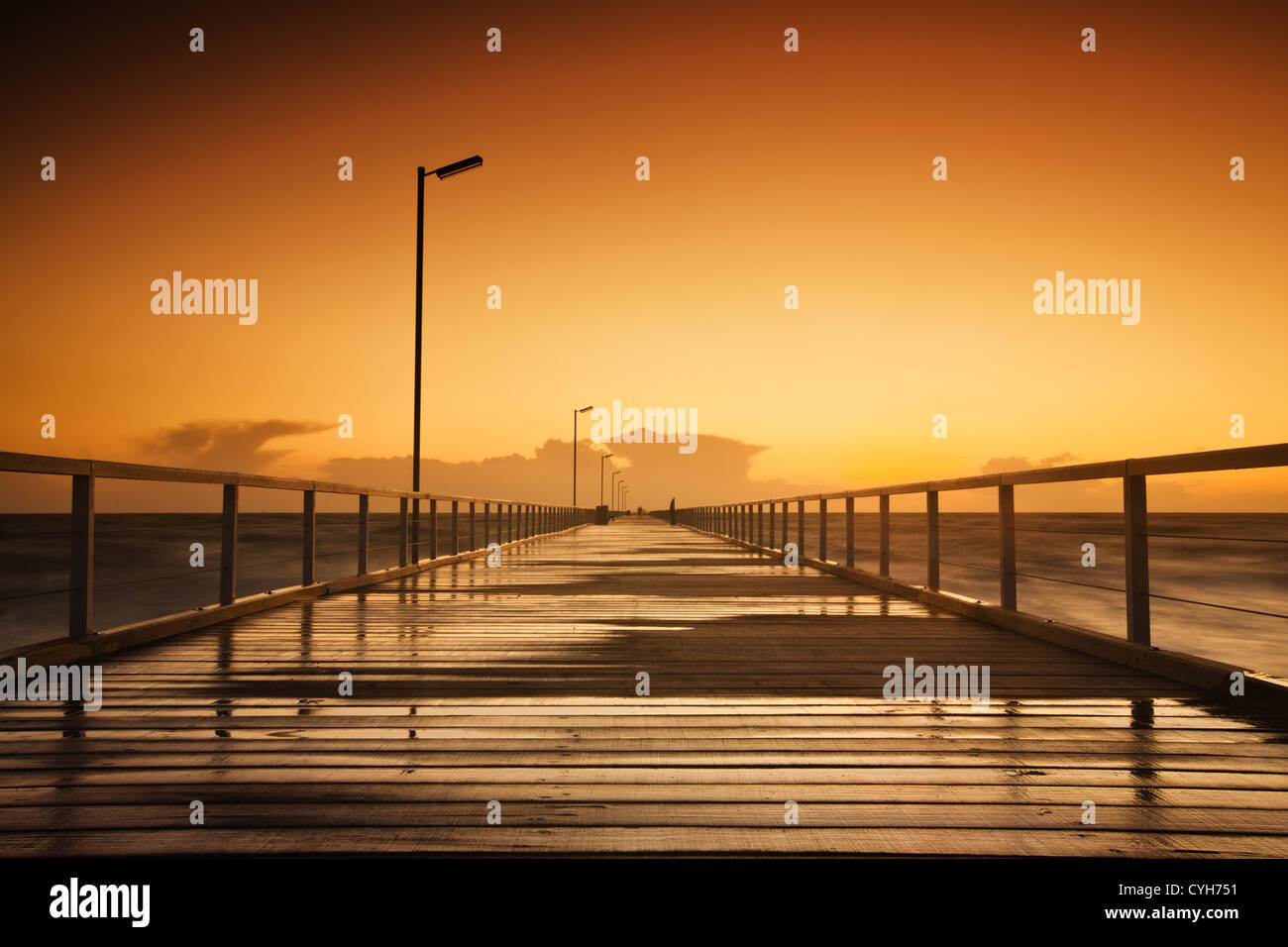 Beautiful sunset over a long jetty Stock Photo - Alamy