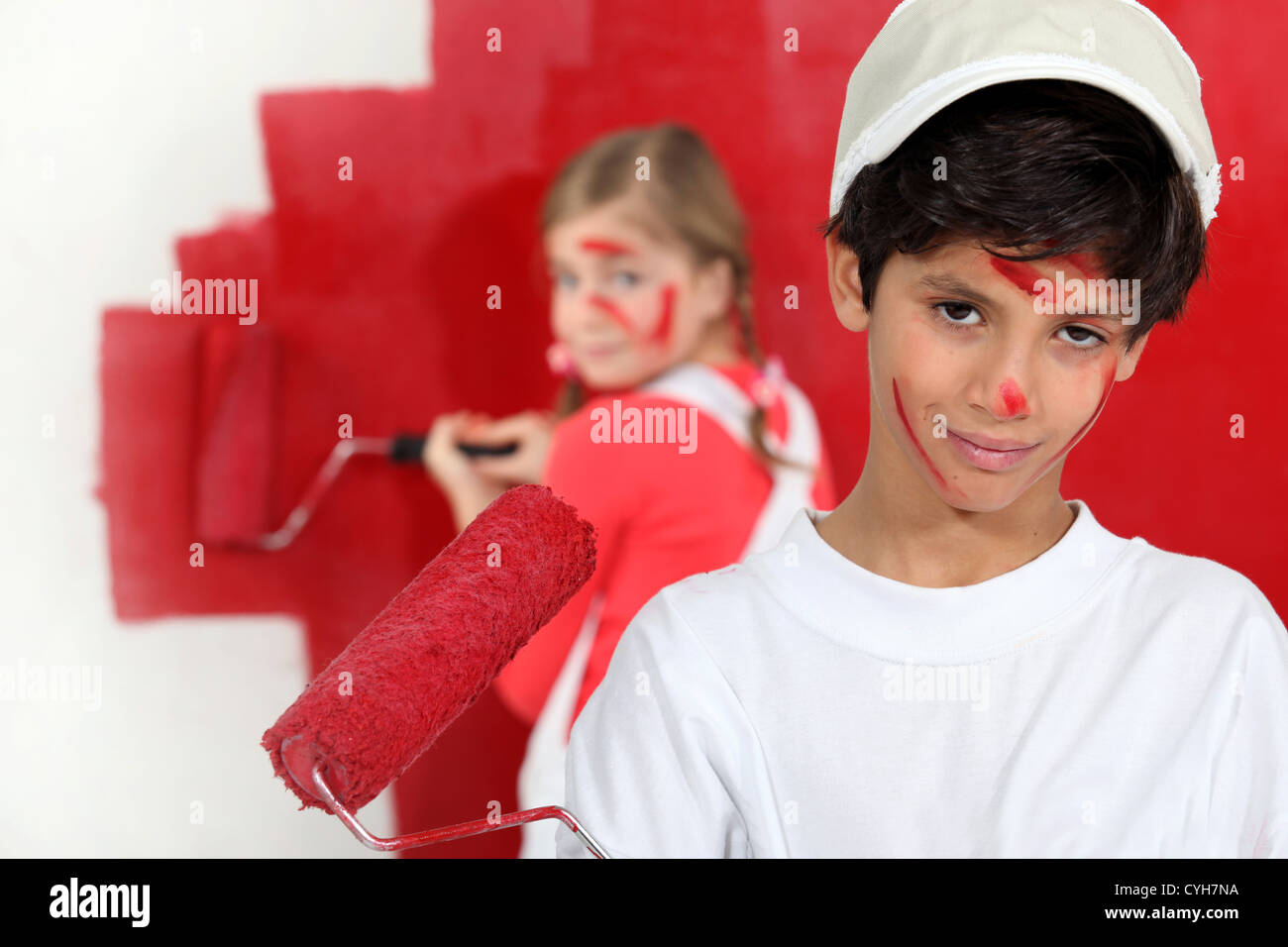 Children painting a room red Stock Photo - Alamy