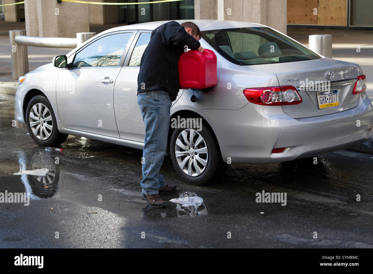 New York City, Nov. 4. 2012. A man in lower Manhattan fills his gas ...