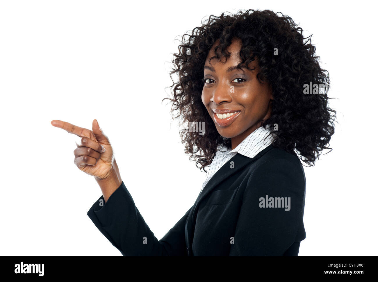 Corporate woman indicating towards copy space while looking at camera ...