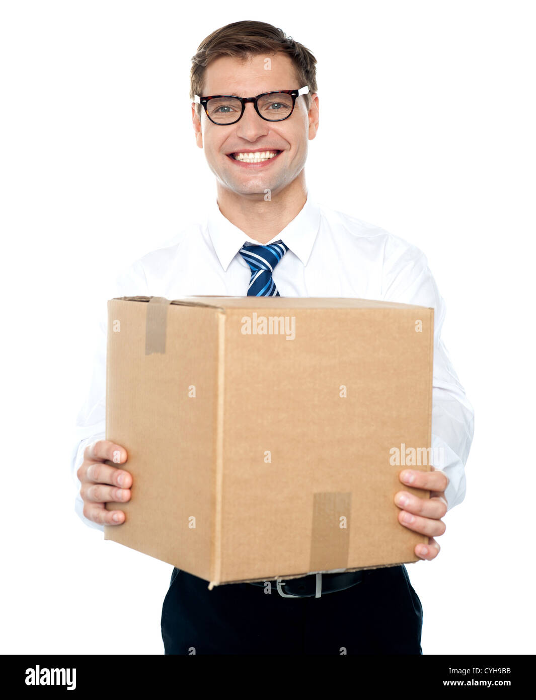 Businessman holding packed carton and posing in front of camera against ...
