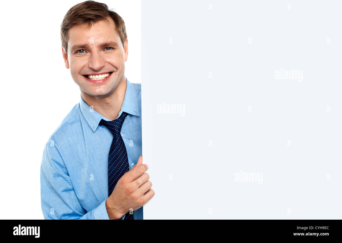 Business man holding a long blank banner ad, smiling at camera Stock ...