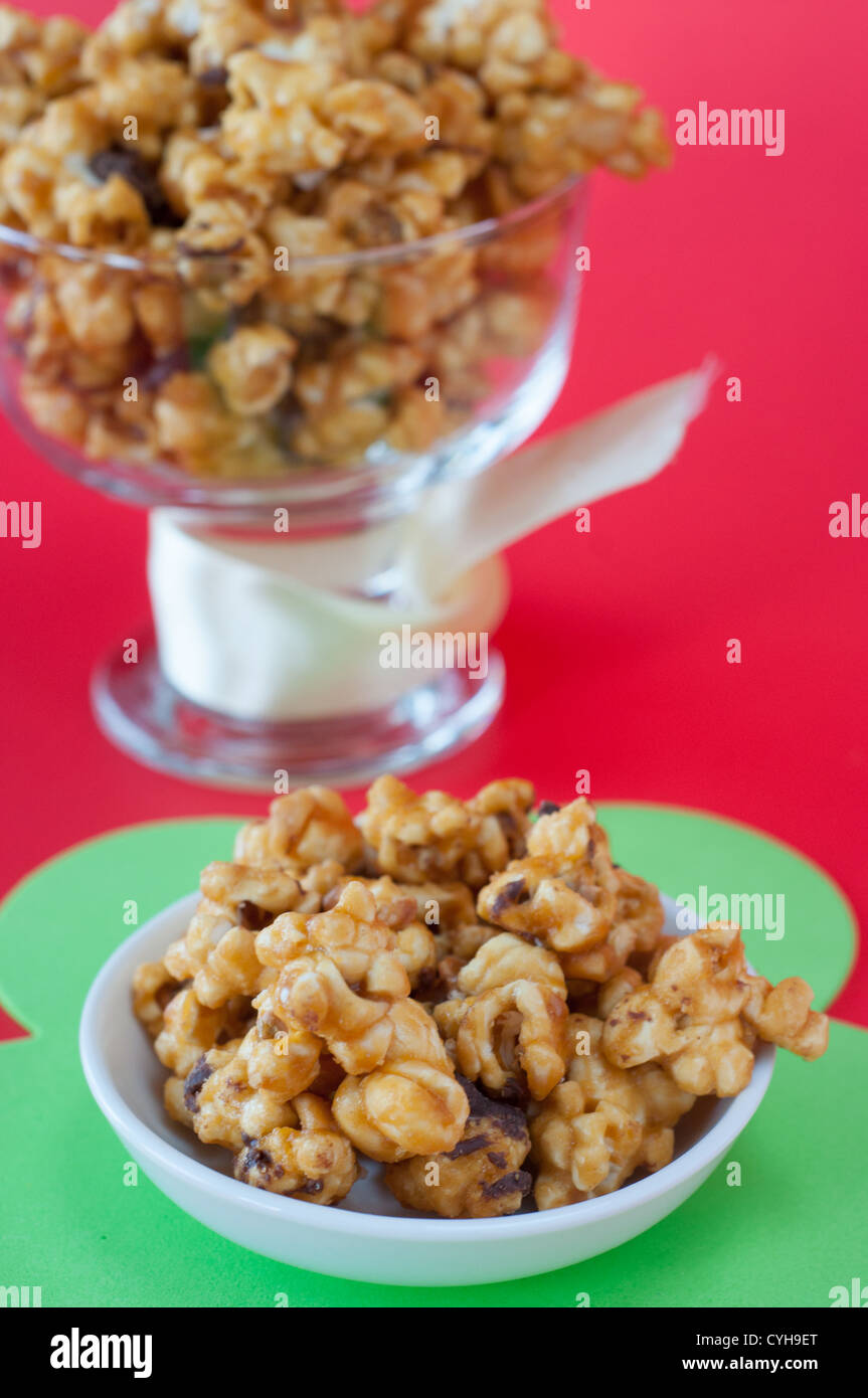 Caramel popcorn on red and green background Stock Photo - Alamy