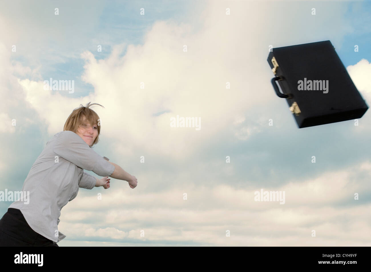 Young business woman throwing briefcase in the air Stock Photo - Alamy