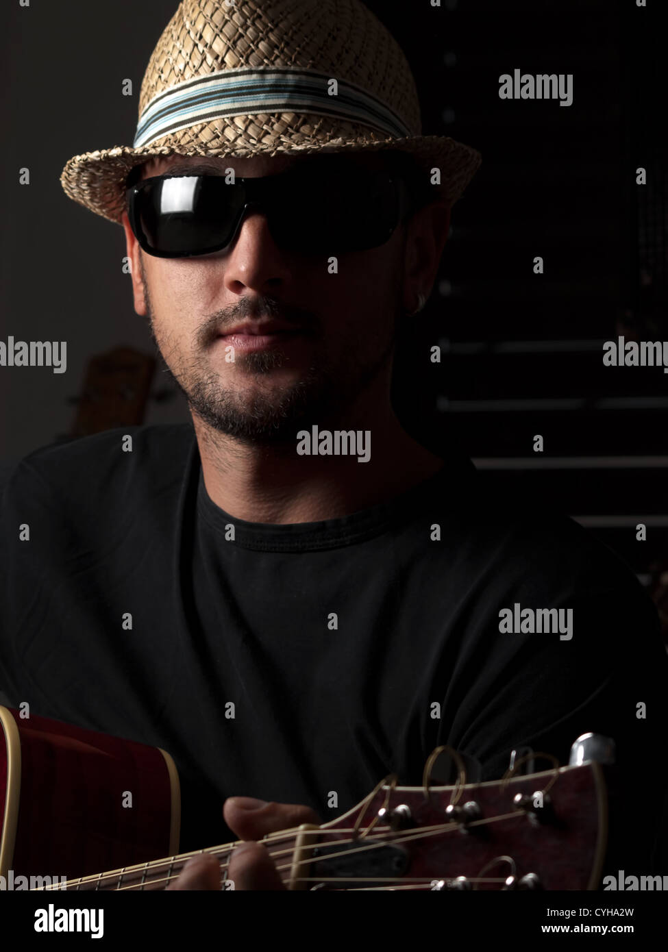 Young man with hat and sunglasses playing guitar, for entertainment ...