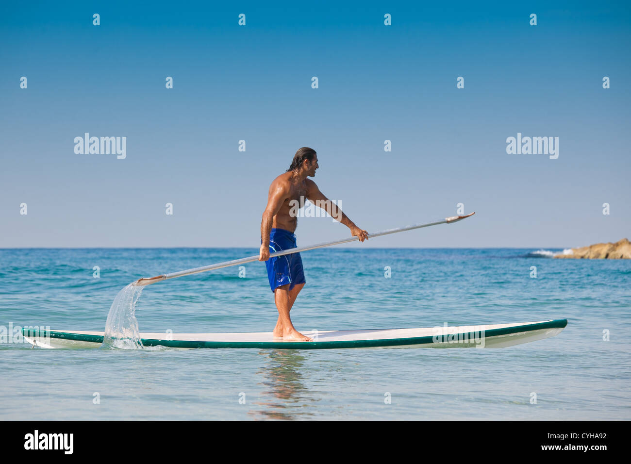 Stand up paddle board man paddle-boarding is standing happy on paddle ...