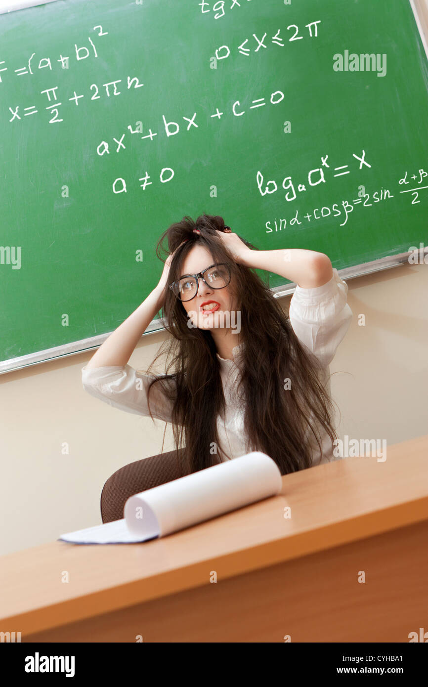 The teacher in the classroom on blackboard background Stock Photo - Alamy