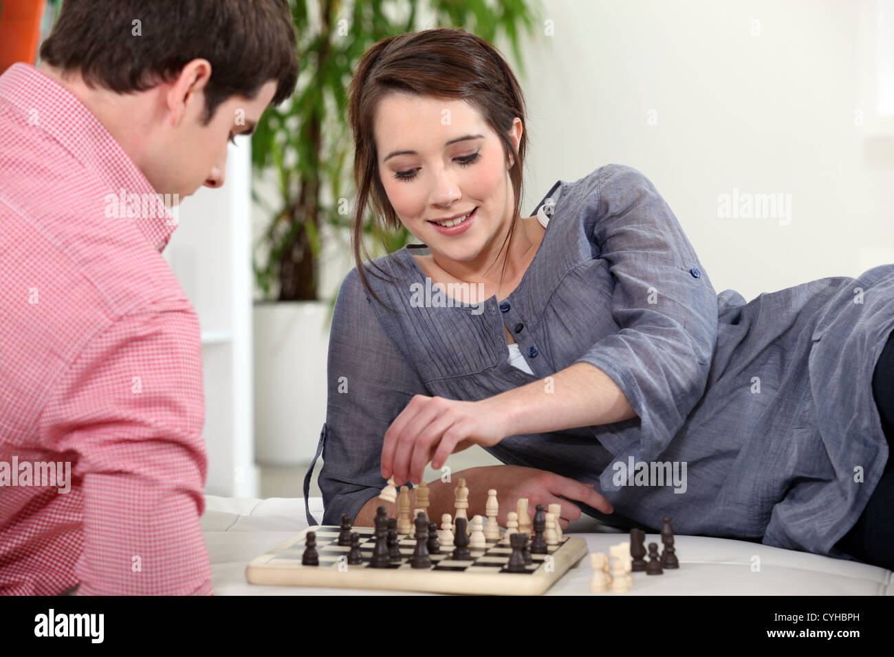 Couple playing chess Stock Photo - Alamy