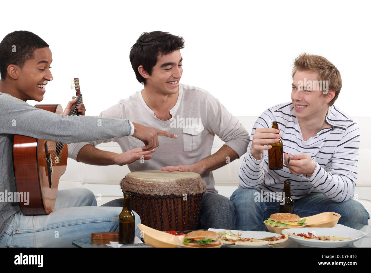 Three male friends playing instruments Stock Photo - Alamy