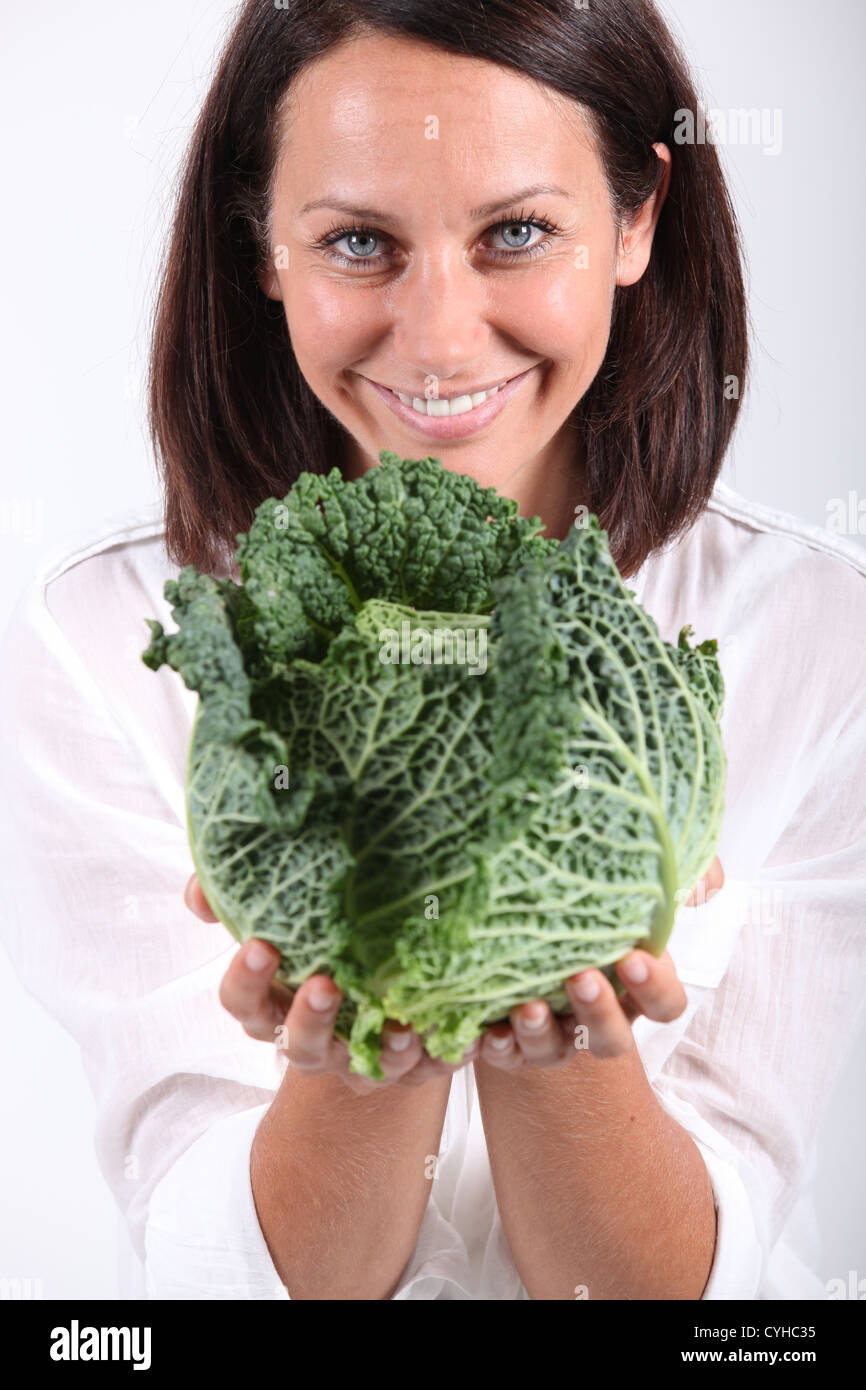 Woman showing cabbage Stock Photo - Alamy