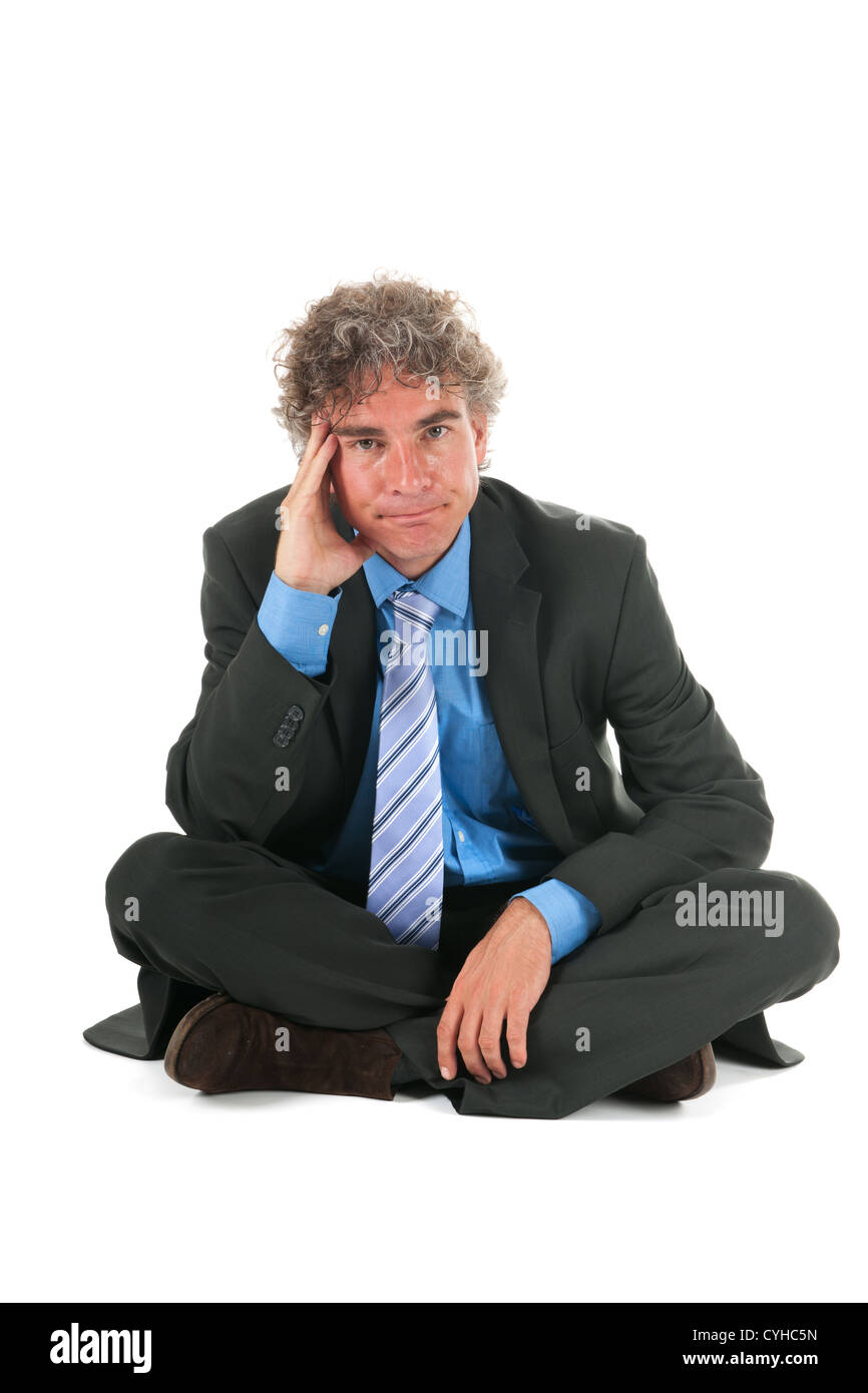 Manager with lots of stress is sitting at the floor with critical face ...