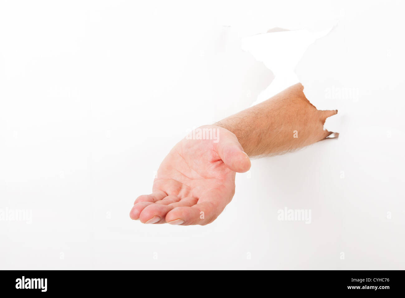 Giving me sign with hand through broken wall Stock Photo - Alamy