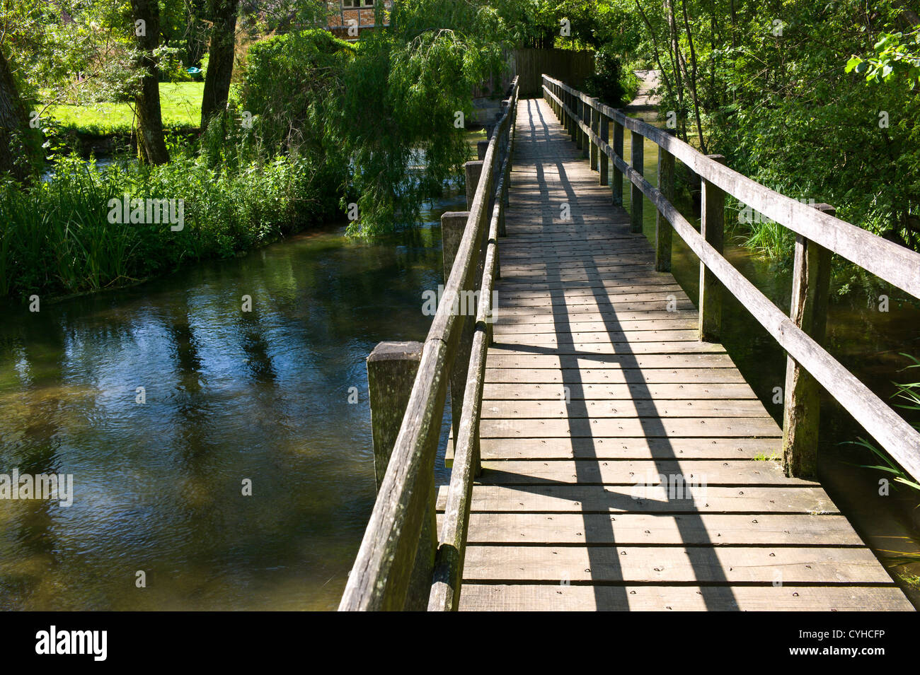 Footbridge across the River Test, a world renowned chalk stream at ...