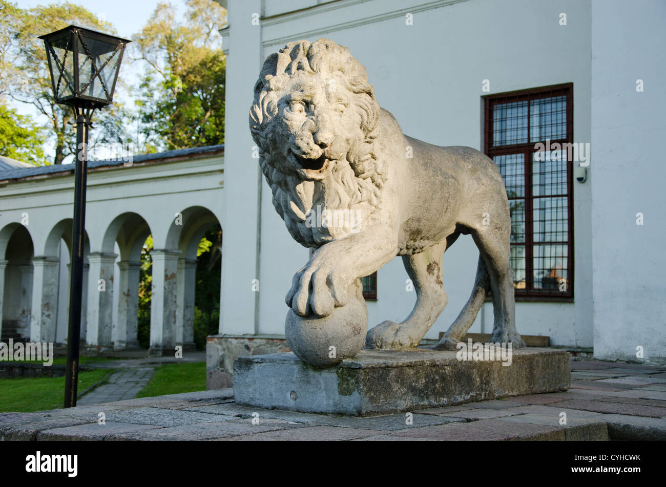 Retro stone lion sunlight with sun in park hold round ball with claw ...