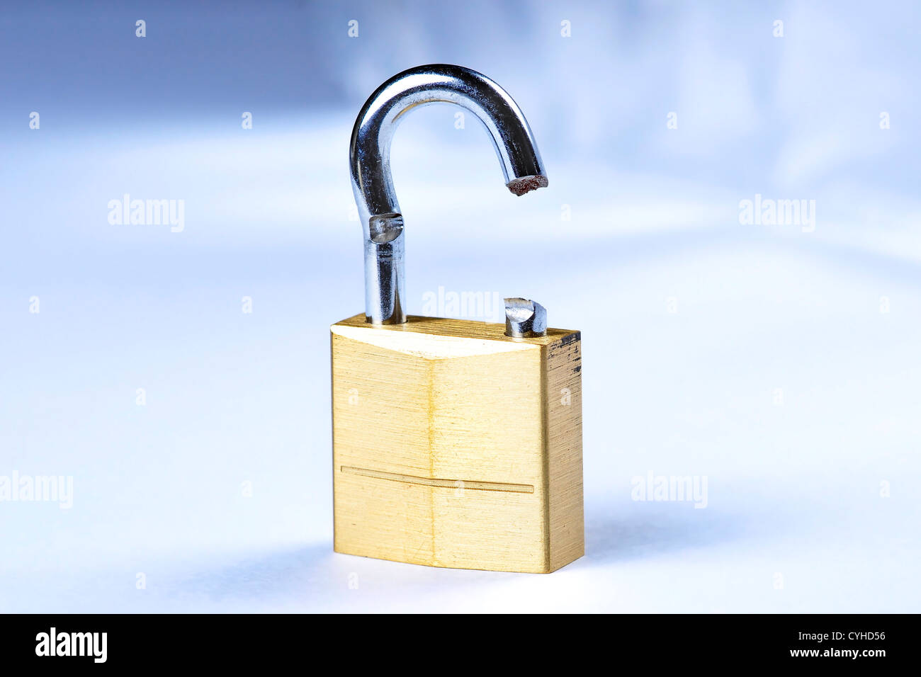 Image of a broken gold lock with a blue background Stock Photo - Alamy