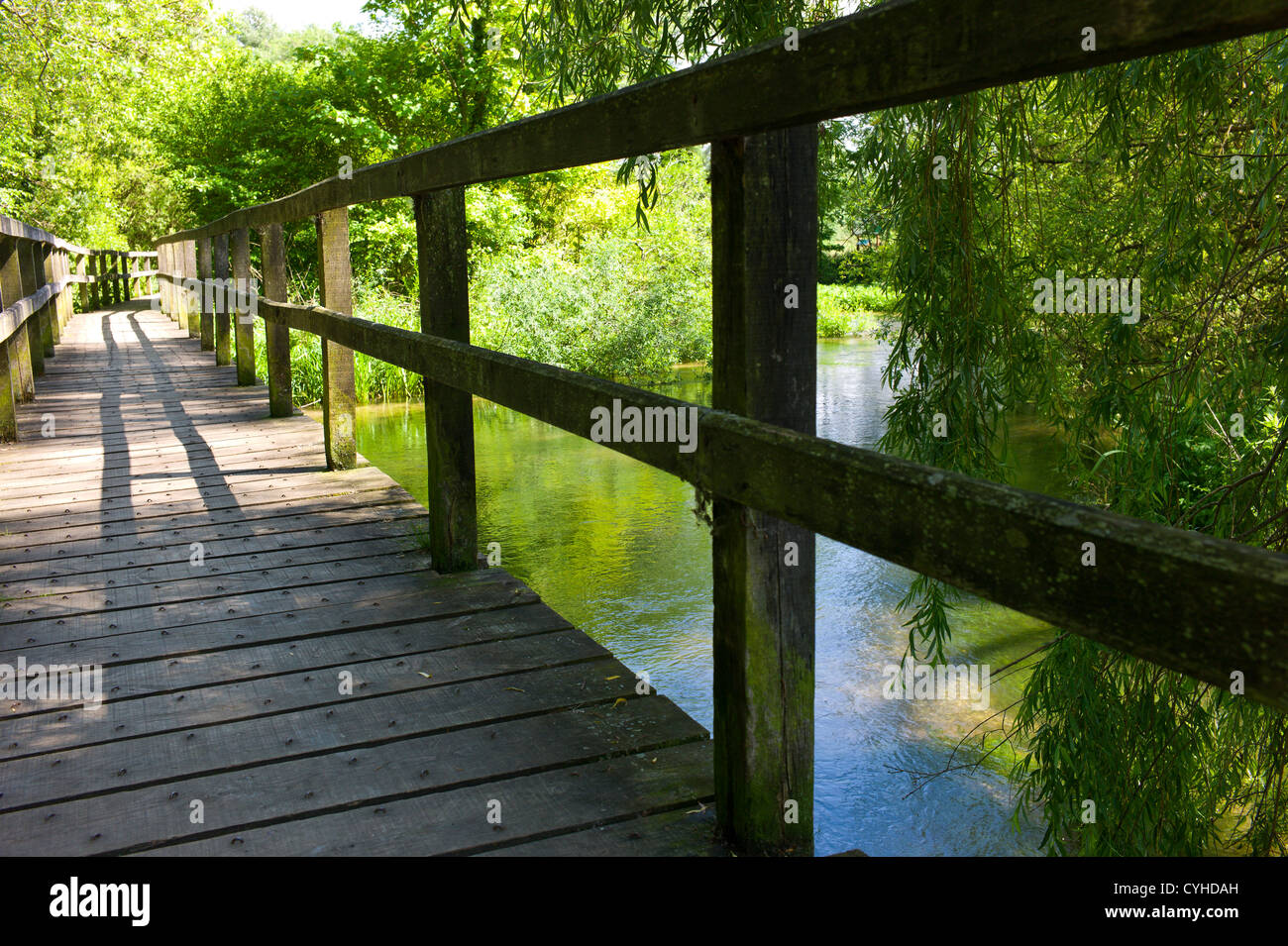 Footbridge across the River Test, a world renowned chalk stream at ...