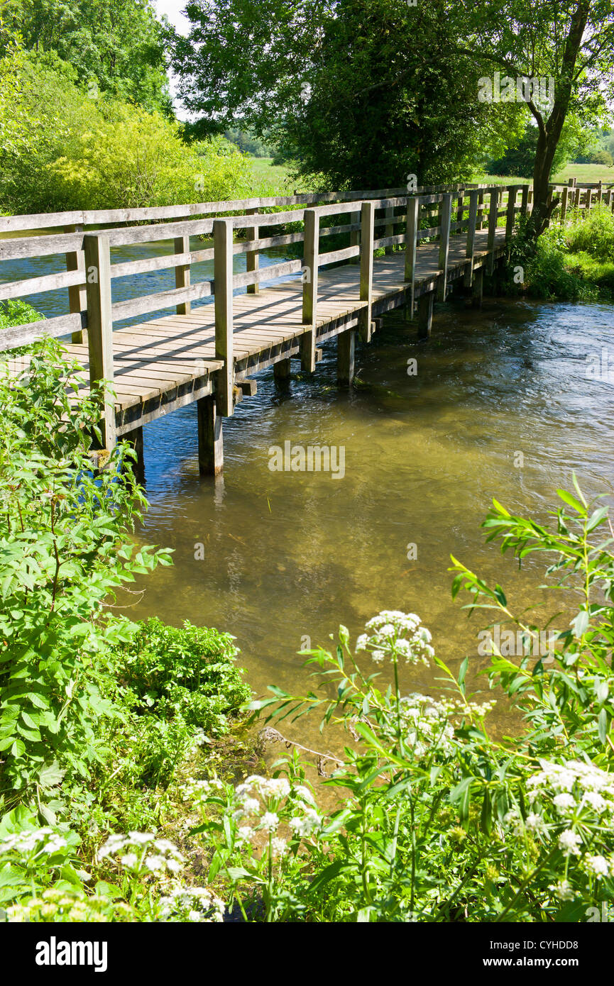 Footbridge across the River Test, a world renowned chalk stream at ...