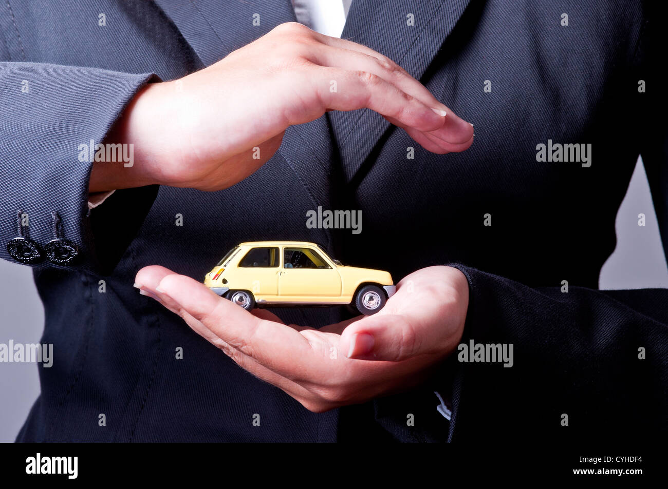 Two hands facing each other, protect a yellow car Stock Photo - Alamy