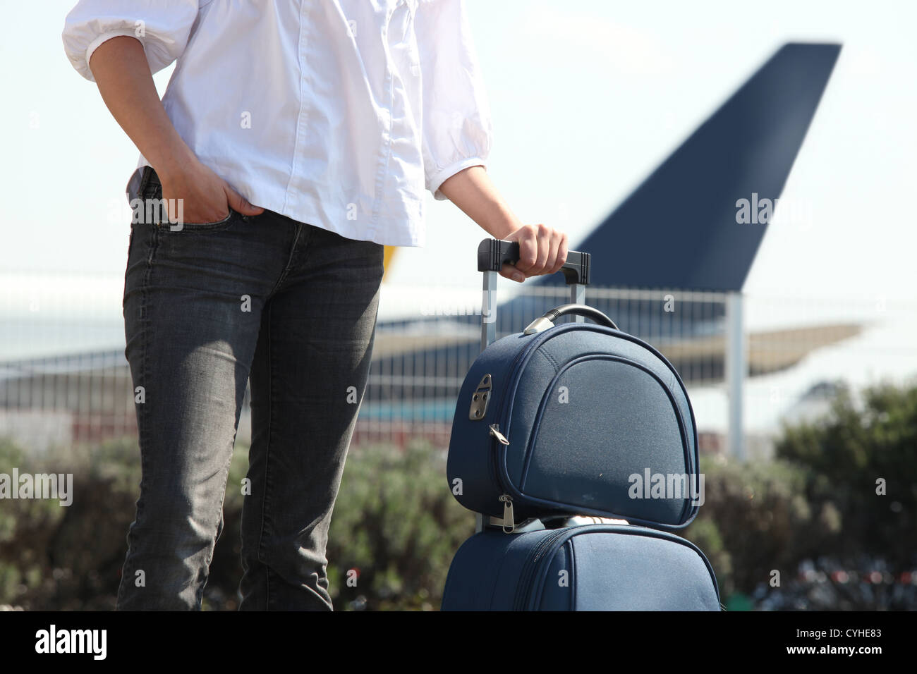 Man arriving at airport with luggage Stock Photo - Alamy