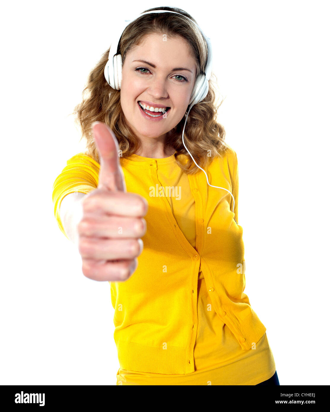 Thumbs-up woman enjoying music on her mp3 player Stock Photo - Alamy