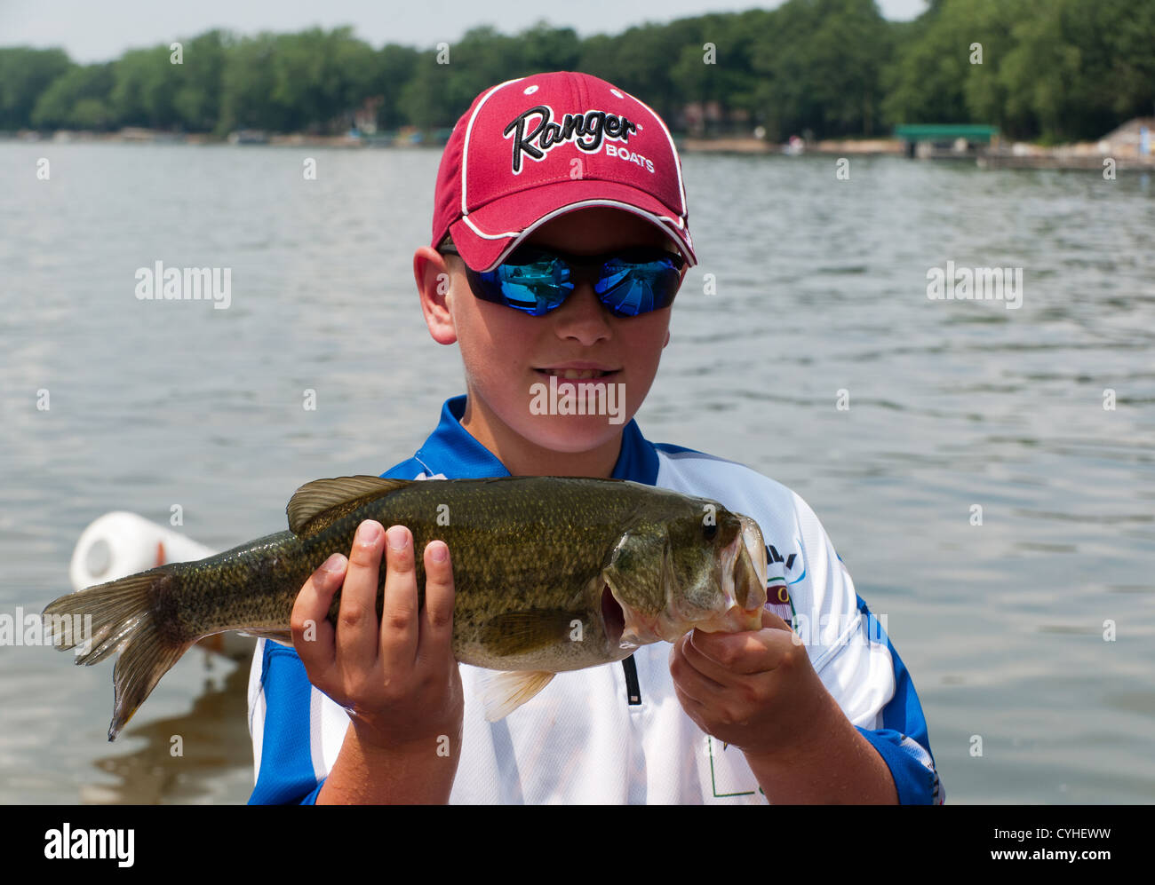 young boy with blue reflective sunglasses holding a fish Stock Photo ...