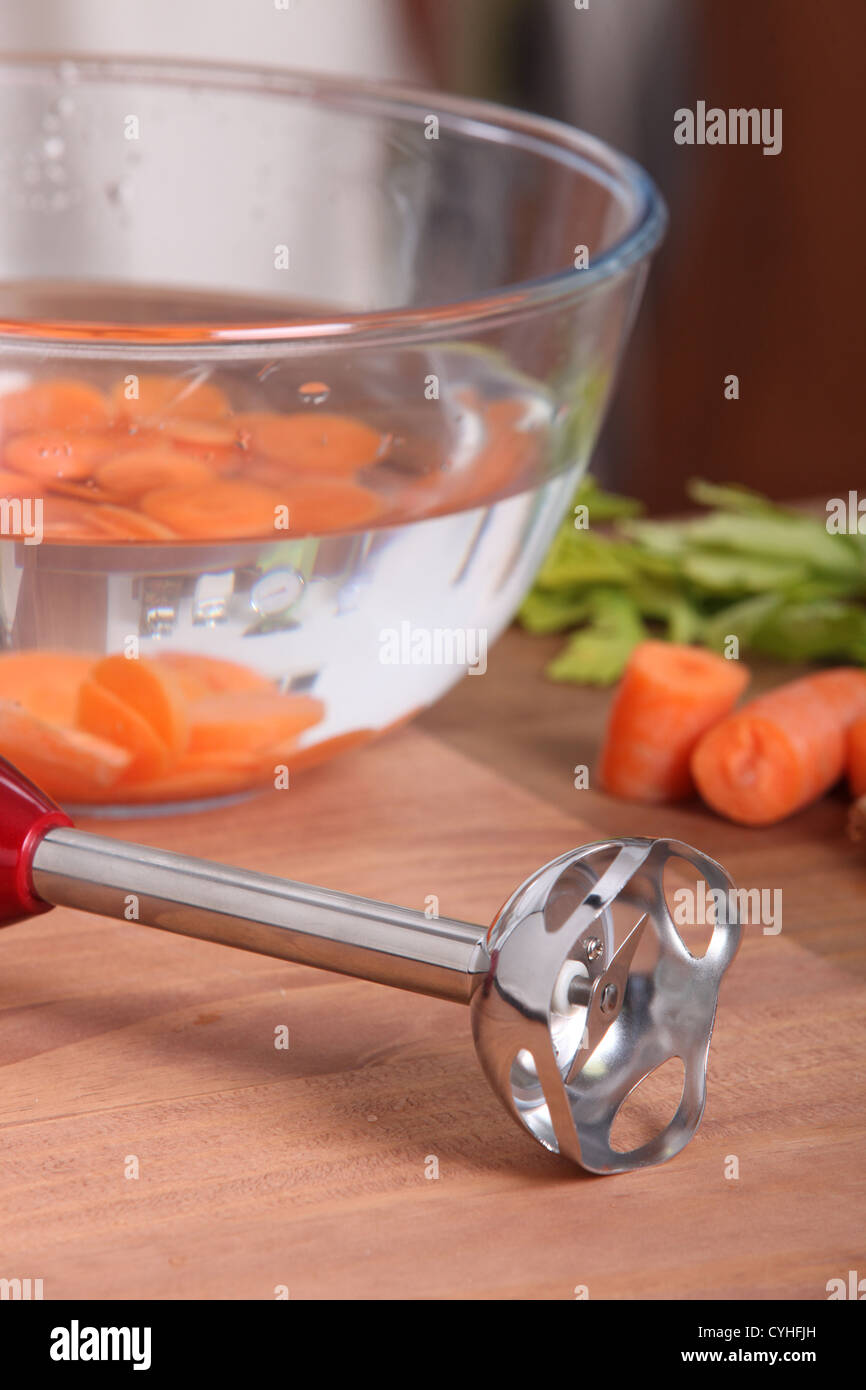 Hand blender and sliced carrots in water Stock Photo - Alamy