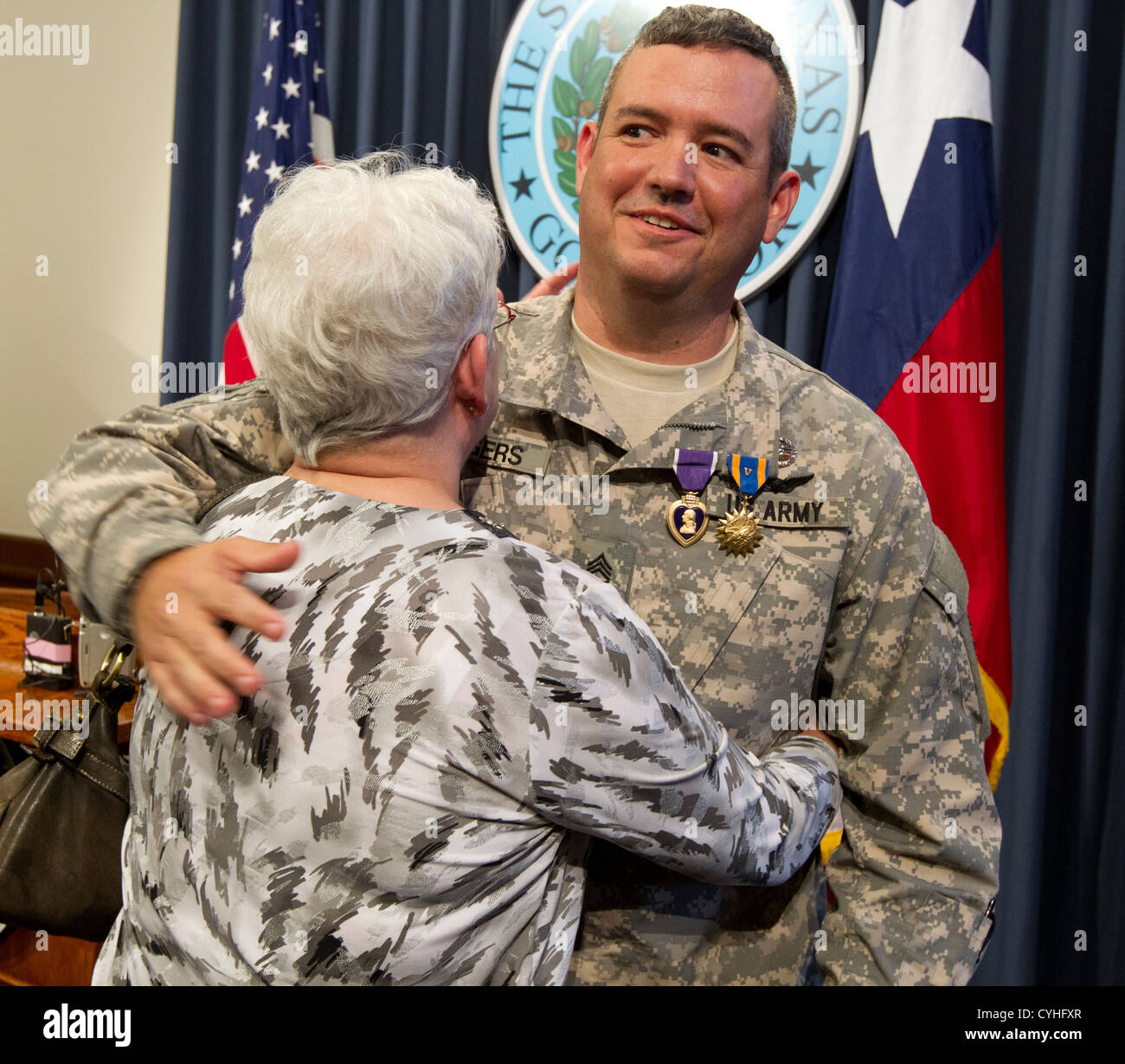 Staff Sergeant Patrick Rogers hugs a well-wisher after receiving the ...