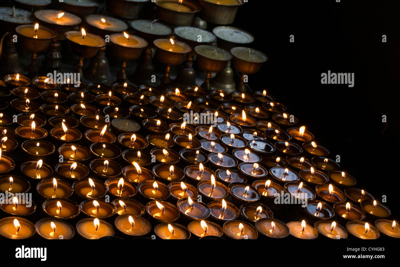 many candles in a row, dark background Stock Photo - Alamy