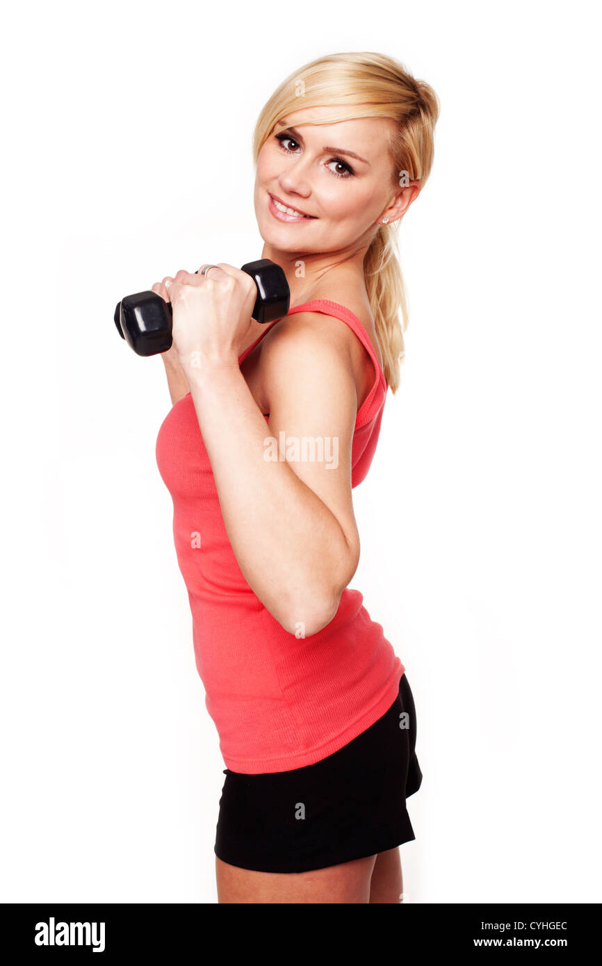 Pretty girl keeping her beautiful shape exercising with hand weights ...