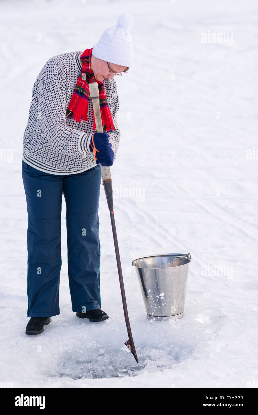 Woman hitting the ice with a ice pick Stock Photo - Alamy