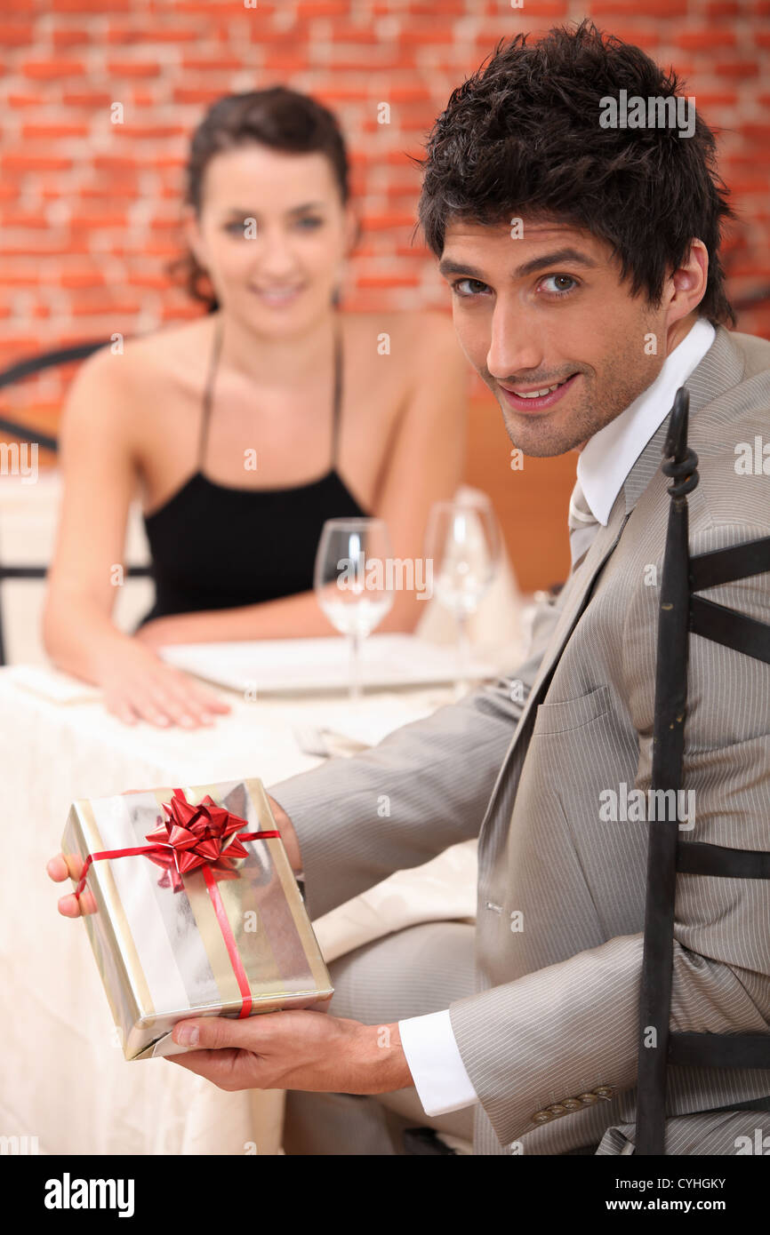 Man giving gift to woman Stock Photo - Alamy