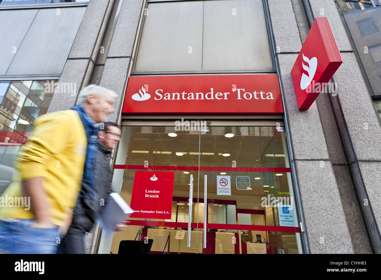 London, UK. 5/11/2012. (Pictured) People walking past a Santander Totta ...