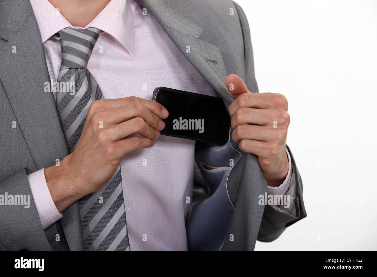 Businessman putting his mobile phone into his pocket Stock Photo - Alamy