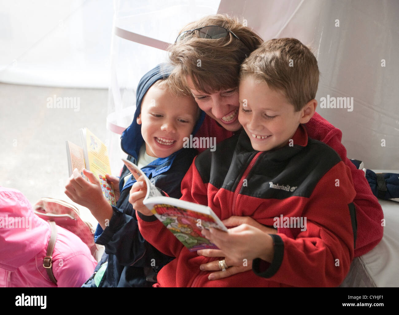 Mother and her sons laugh while reading children's book during Texas ...