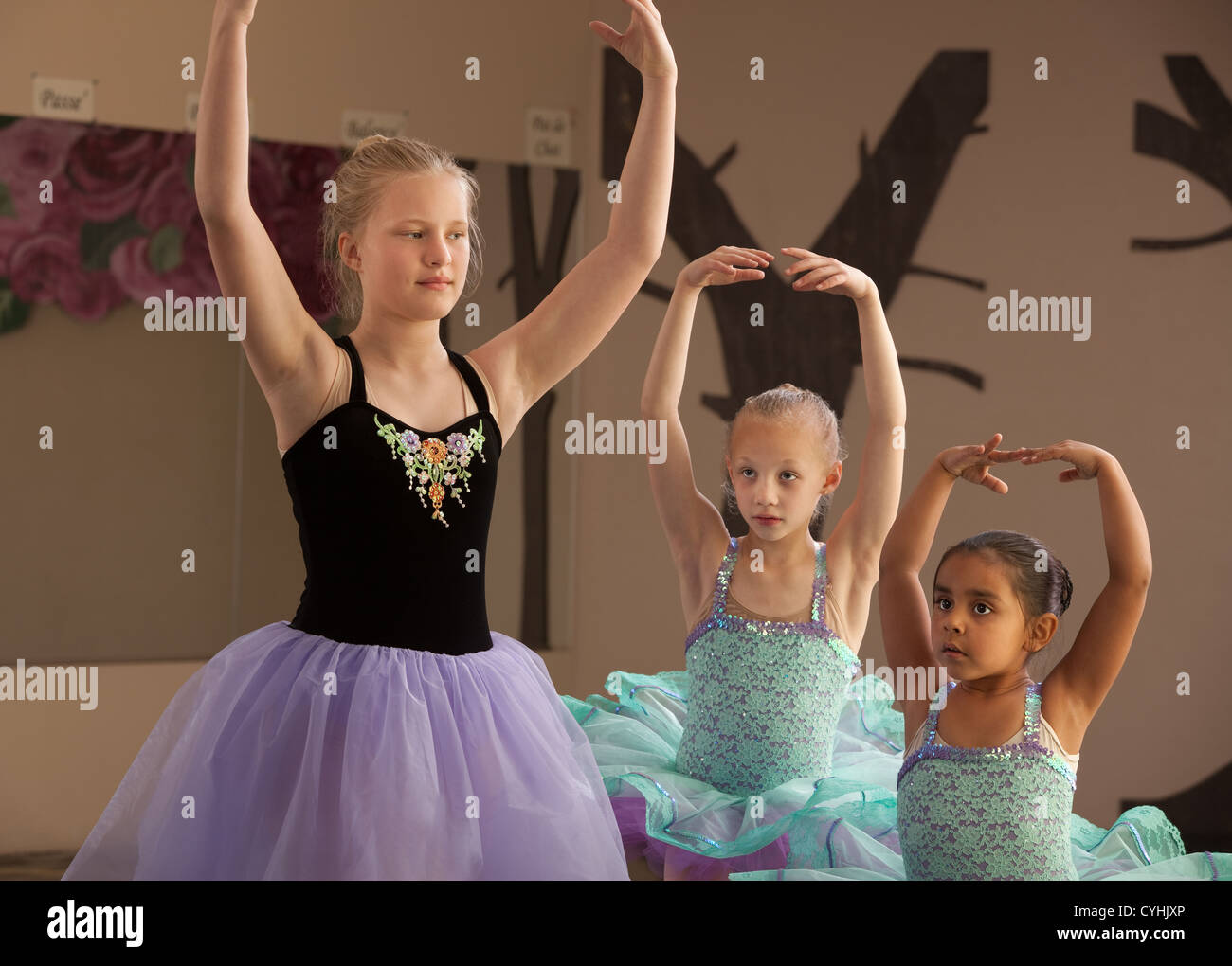 Three female dance students of different ages practicing together Stock ...