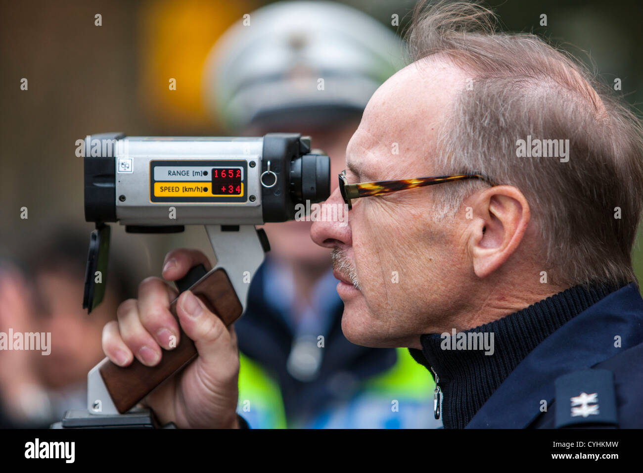Police speed control. Laser measuring of car speed Stock Photo - Alamy