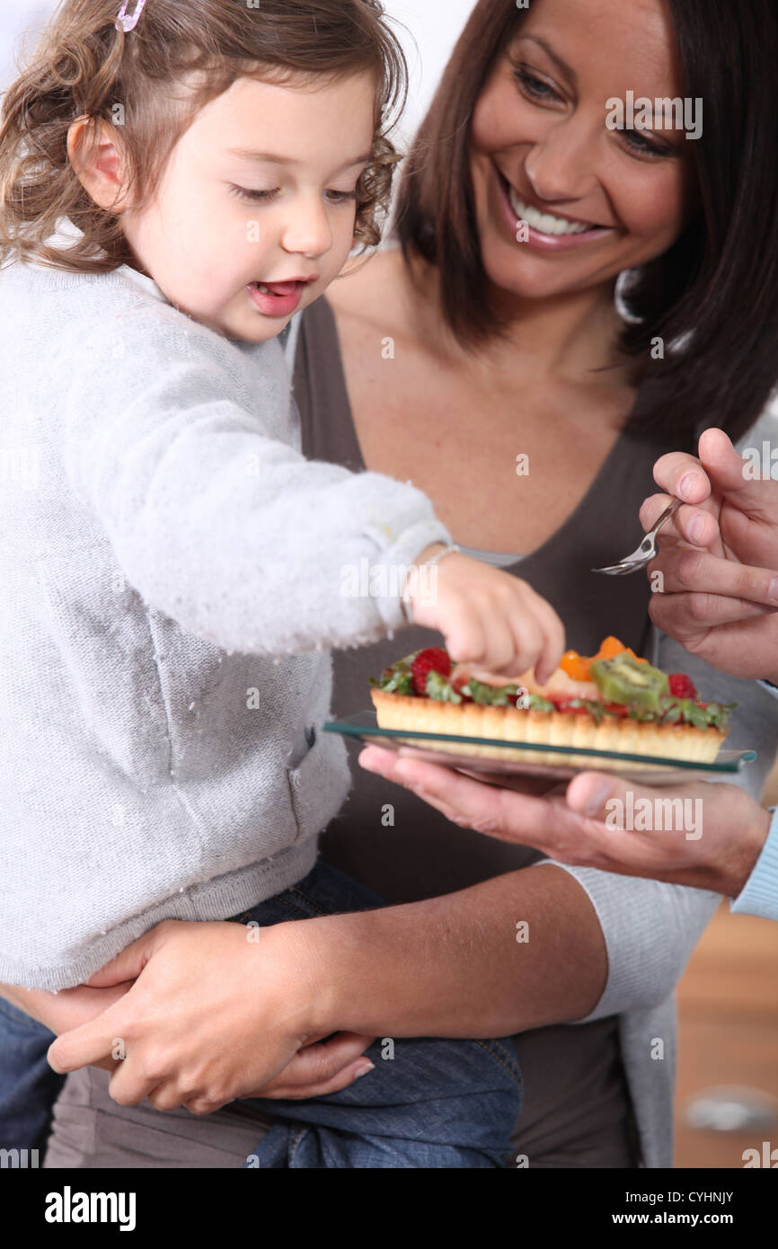 Family eating cake together Stock Photo - Alamy