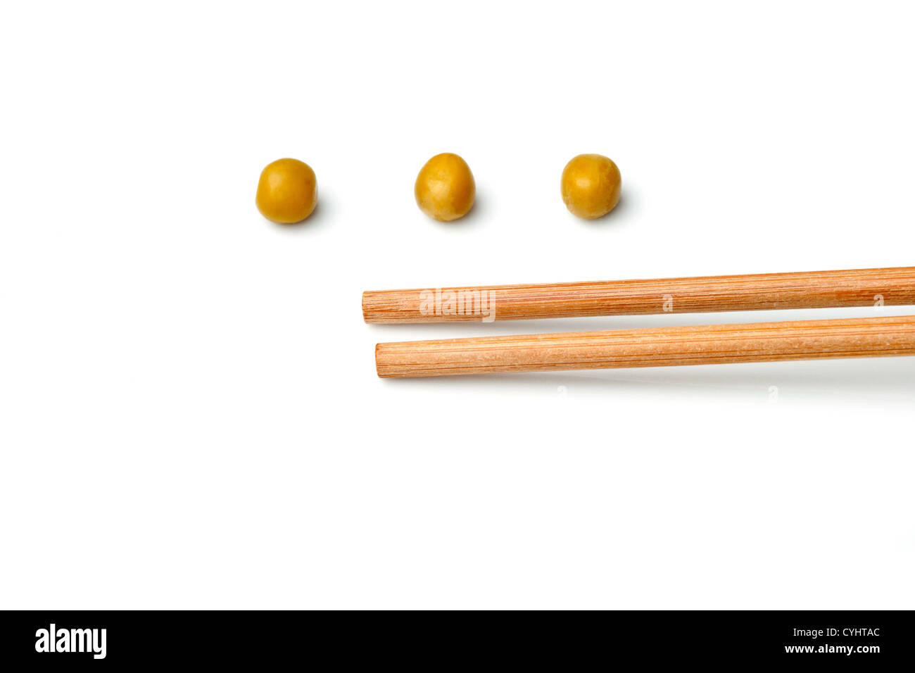 Three green peas and a pair of chop sticks Stock Photo - Alamy