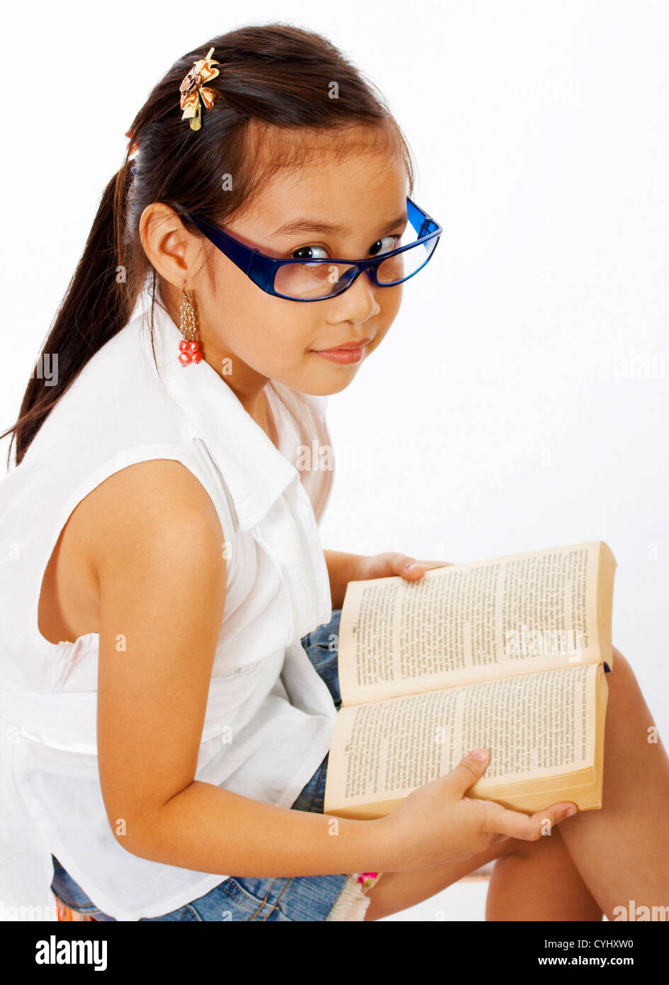 Small Girl Improving Her Education By Reading A Book Stock Photo - Alamy