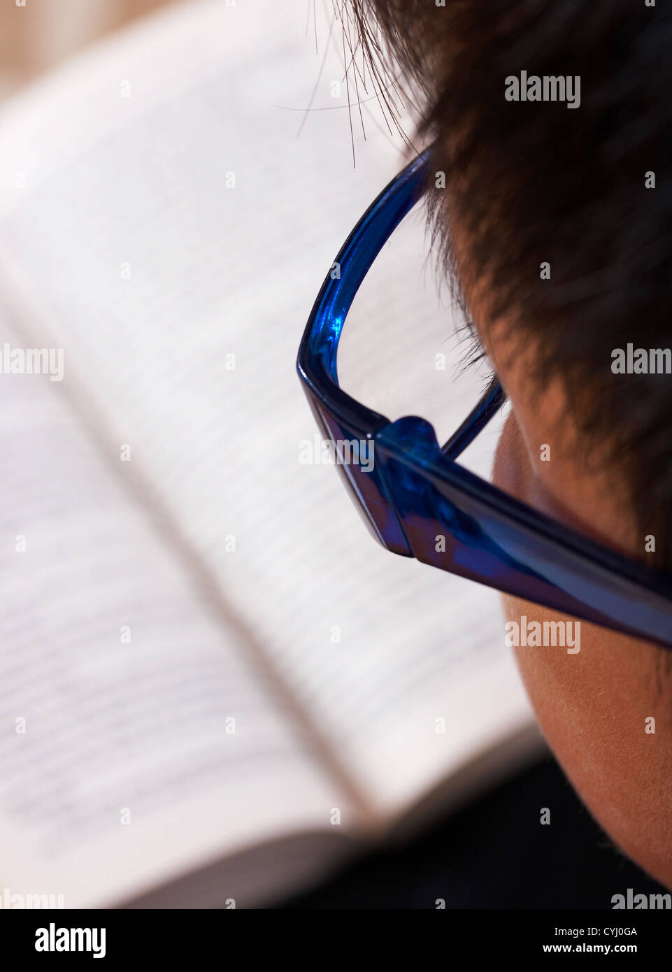 Clever Kid Wearing Glasses Getting Education By Reading A Book Stock ...