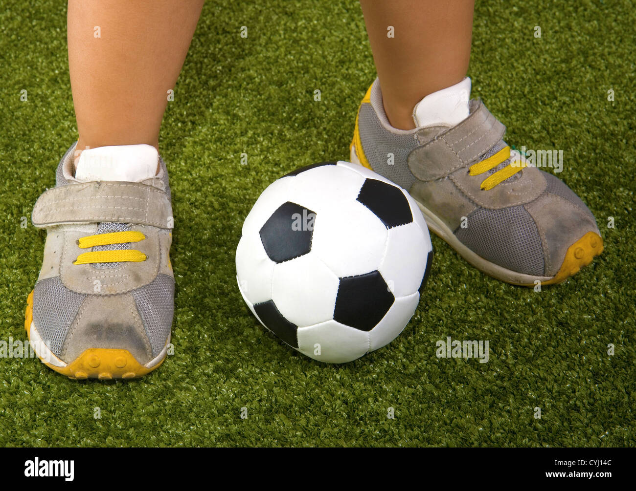Young Kid Active Outdoors Kicking A Ball Around Stock Photo - Alamy