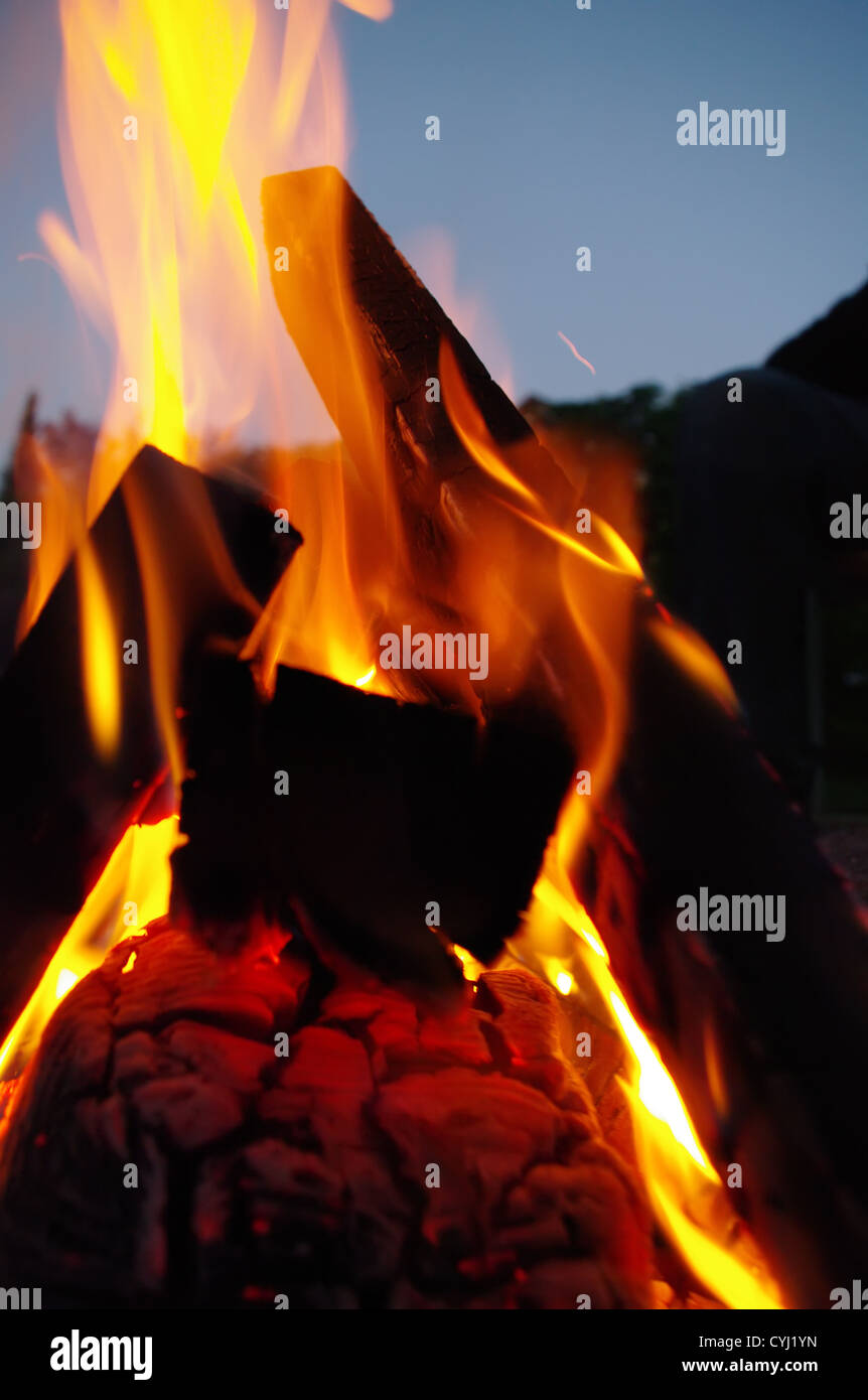 a nice campfire burning outside in summer Stock Photo - Alamy