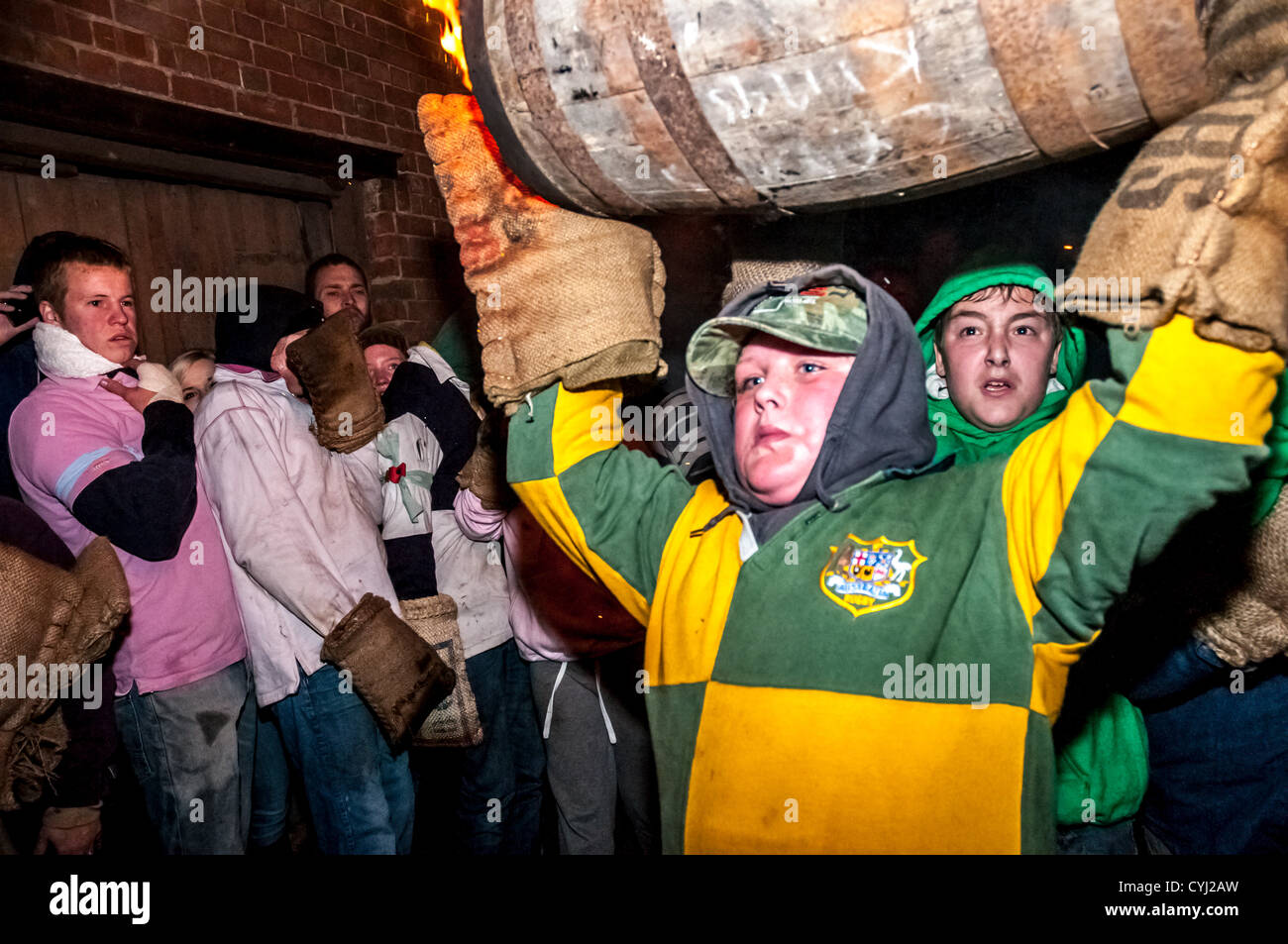 Young barrel rollers run through the crowd and the streets of Ottery St ...