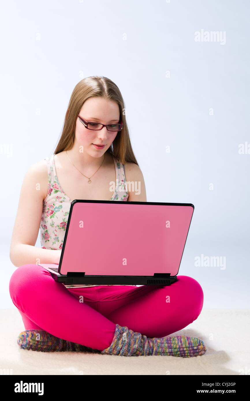 A young beautiful girl concentrate and using her pink laptop Stock ...