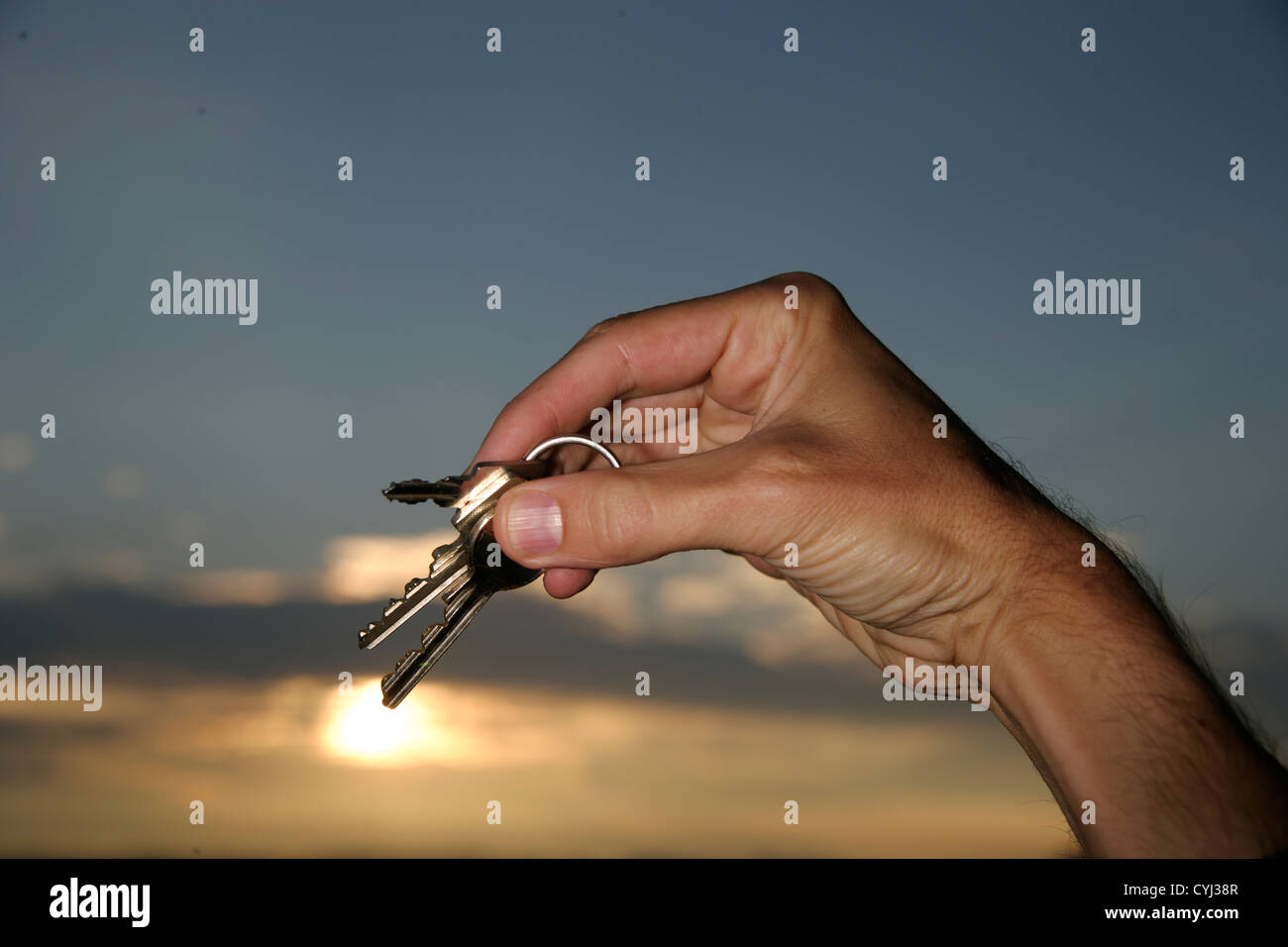 Hand holding keys Stock Photo - Alamy